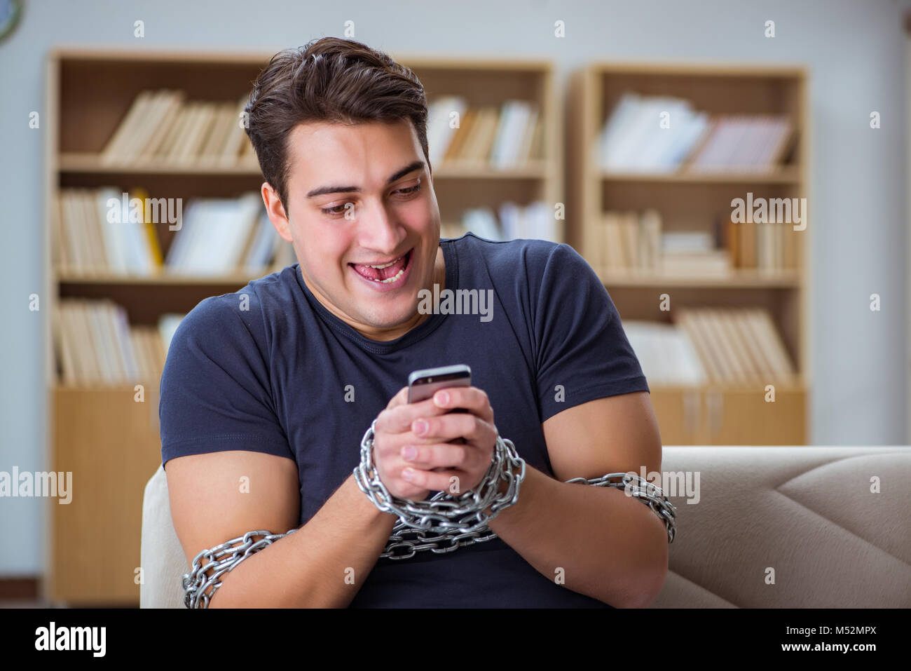 Man suffering from phone dependence addiction Stock Photo - Alamy