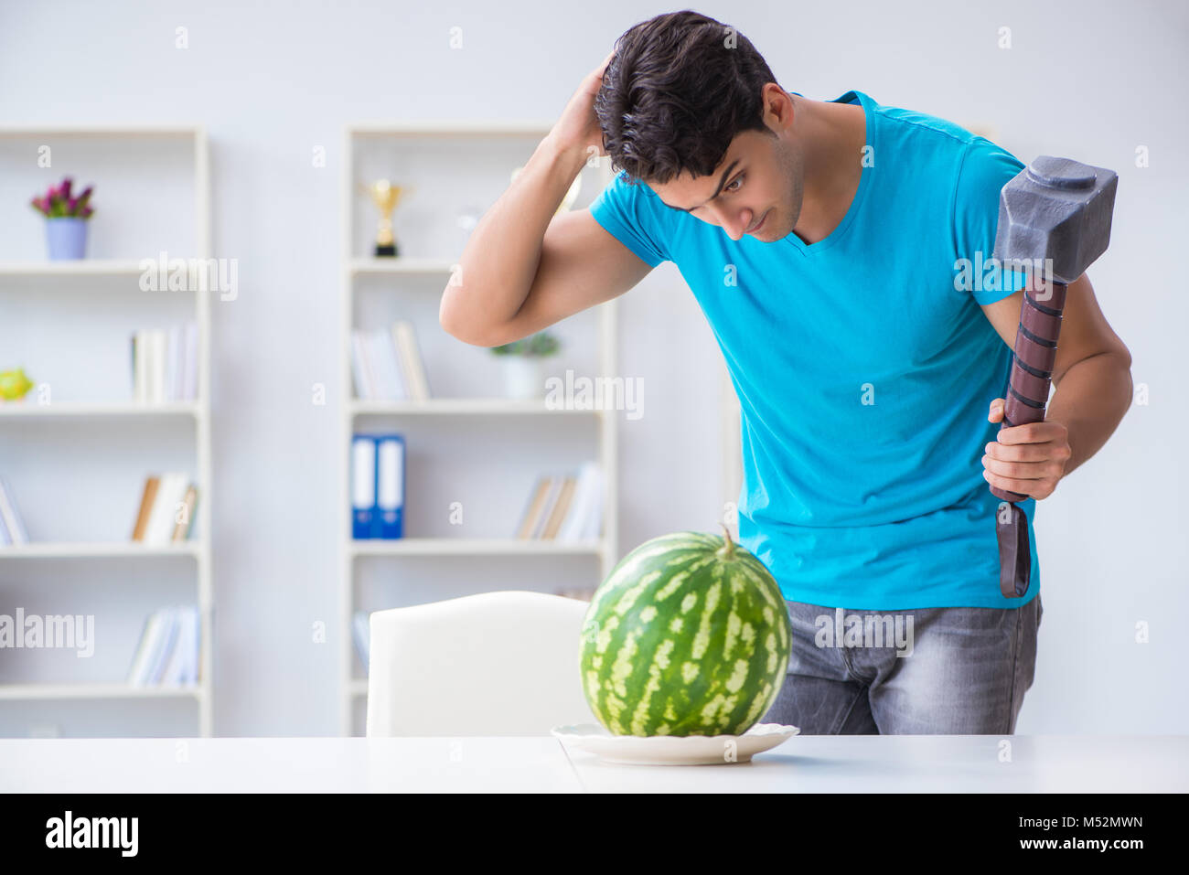 Man eating watermelon at home Stock Photo - Alamy