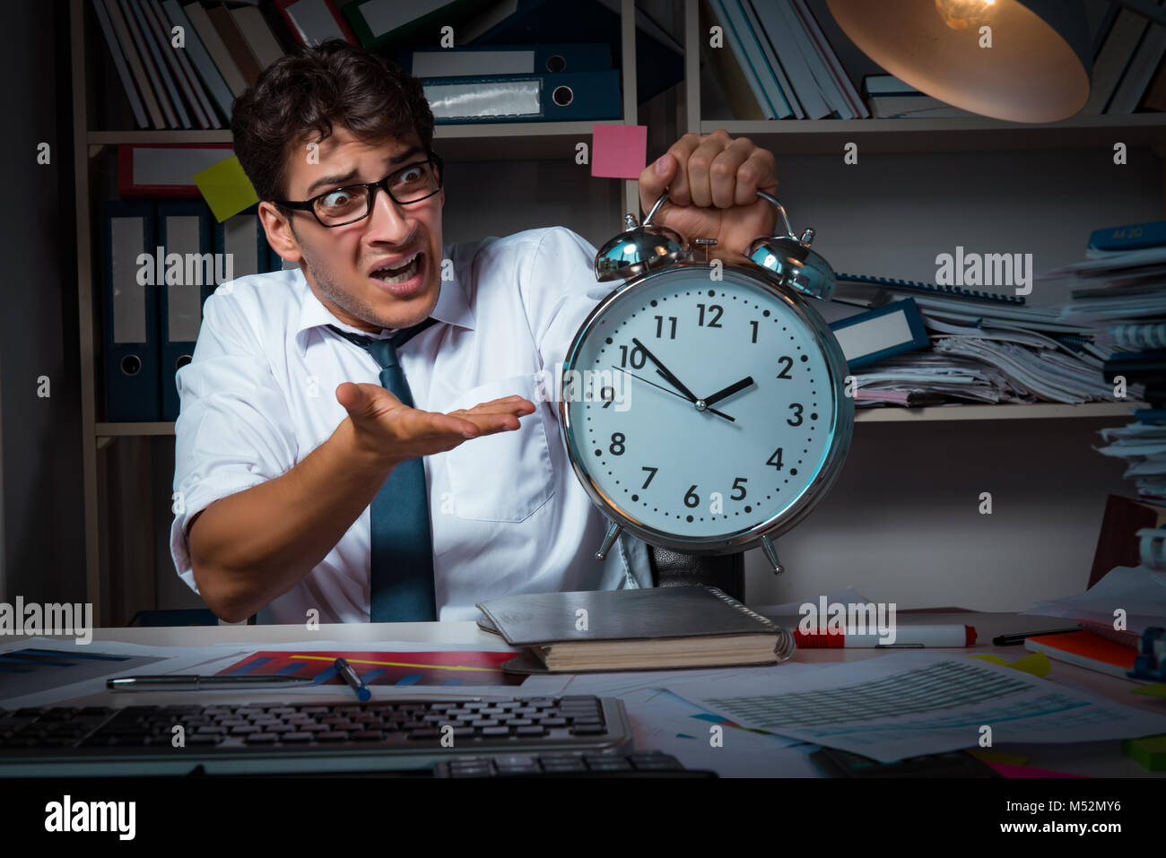 Man businessman working late hours in the office Stock Photo - Alamy