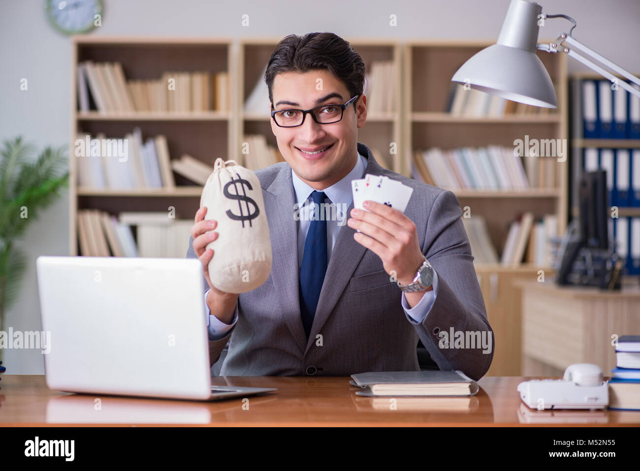 Businessman gambling playing cards at work Stock Photo - Alamy