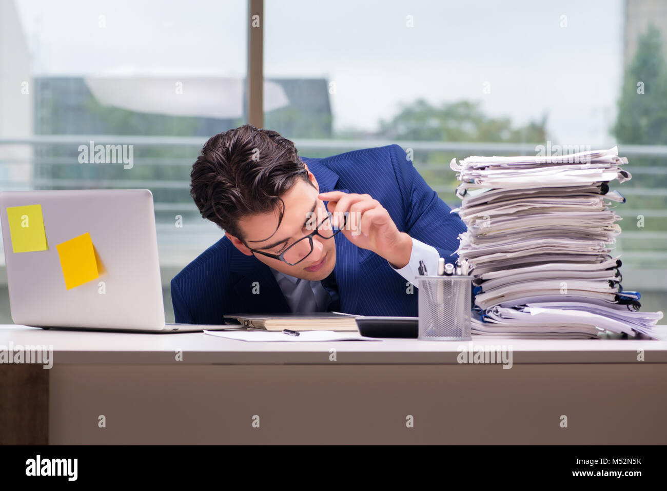 Workaholic businessman overworked with too much work in office Stock ...