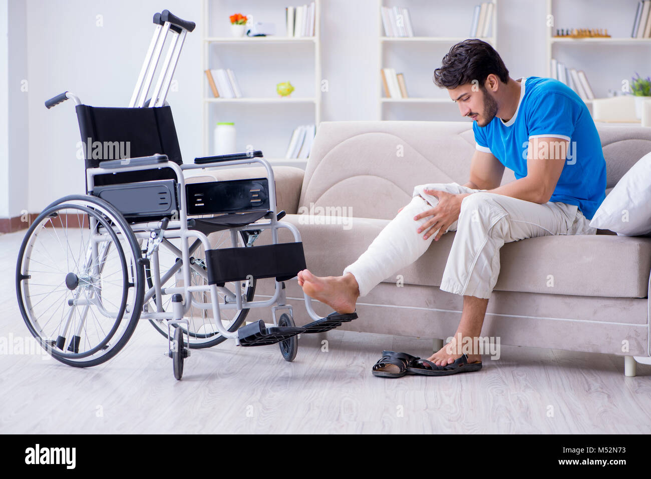 Injured young man recovering at home Stock Photo - Alamy