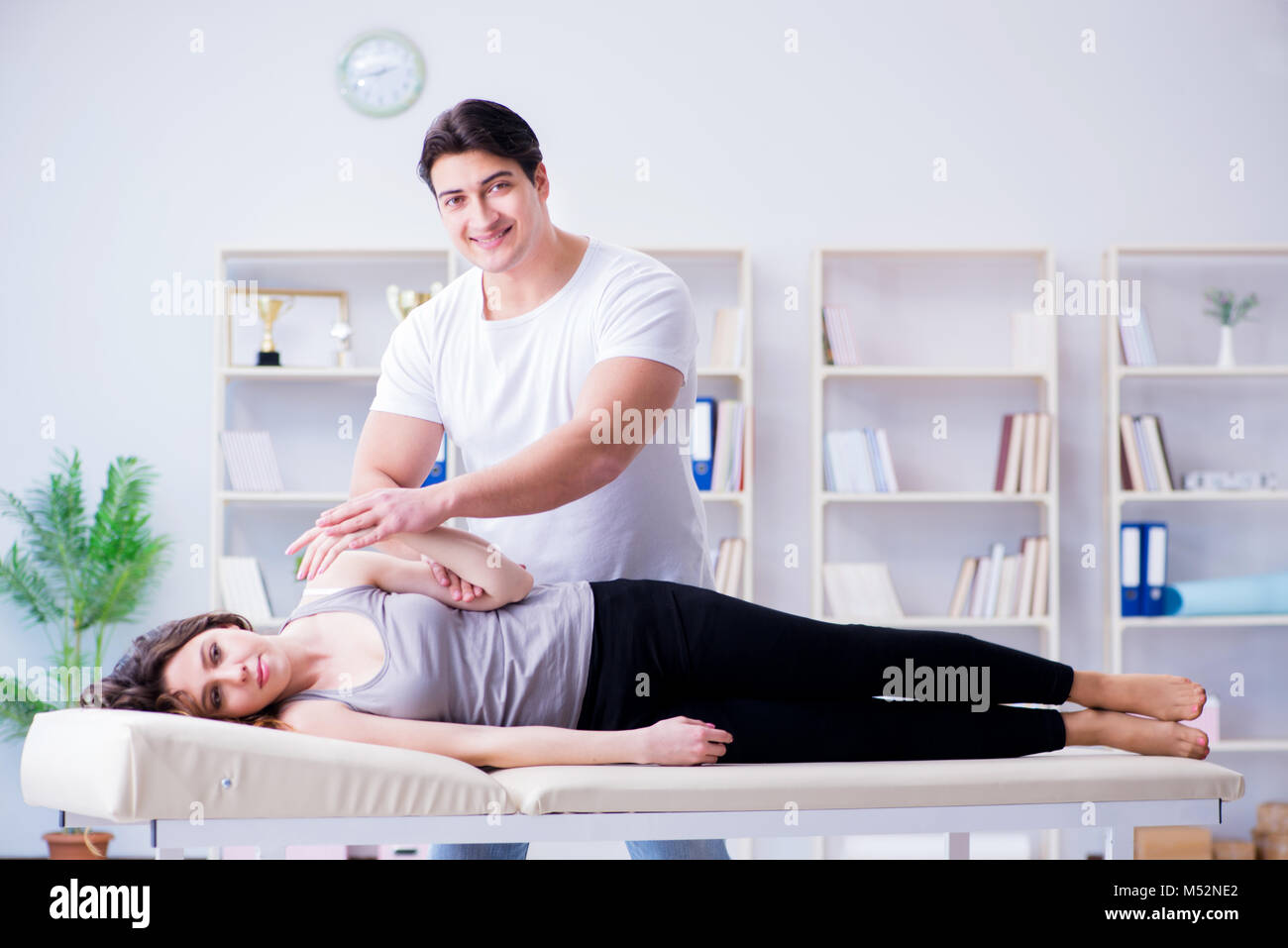 Young doctor chiropractor massaging female patient woman Stock Photo ...