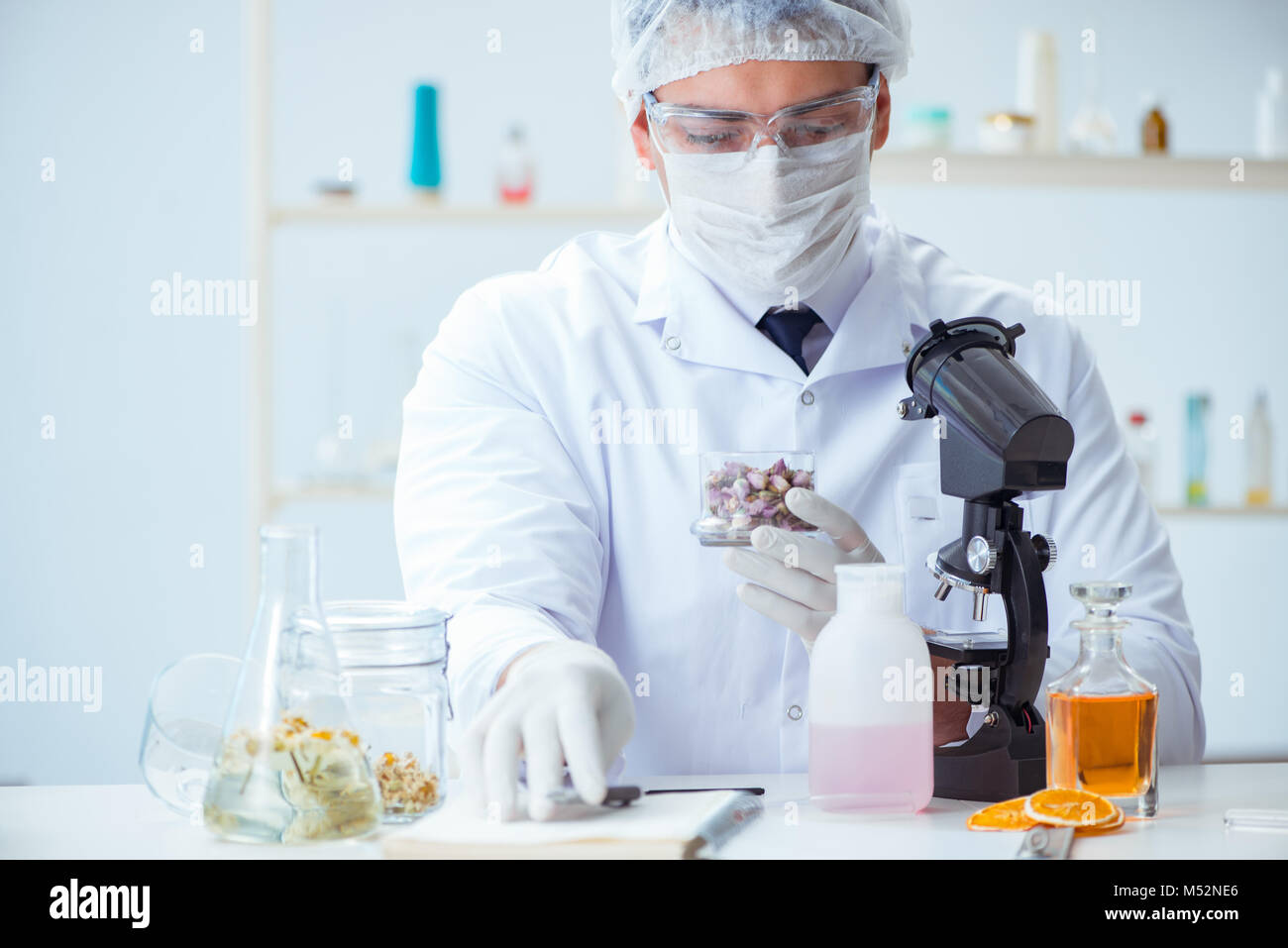 Chemist mixing perfumes in the lab Stock Photo - Alamy