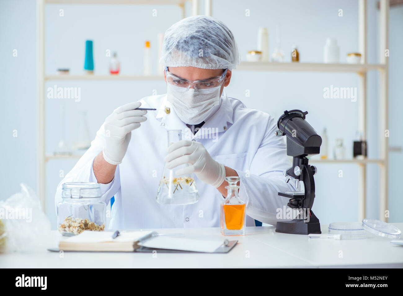 Chemist mixing perfumes in the lab Stock Photo - Alamy