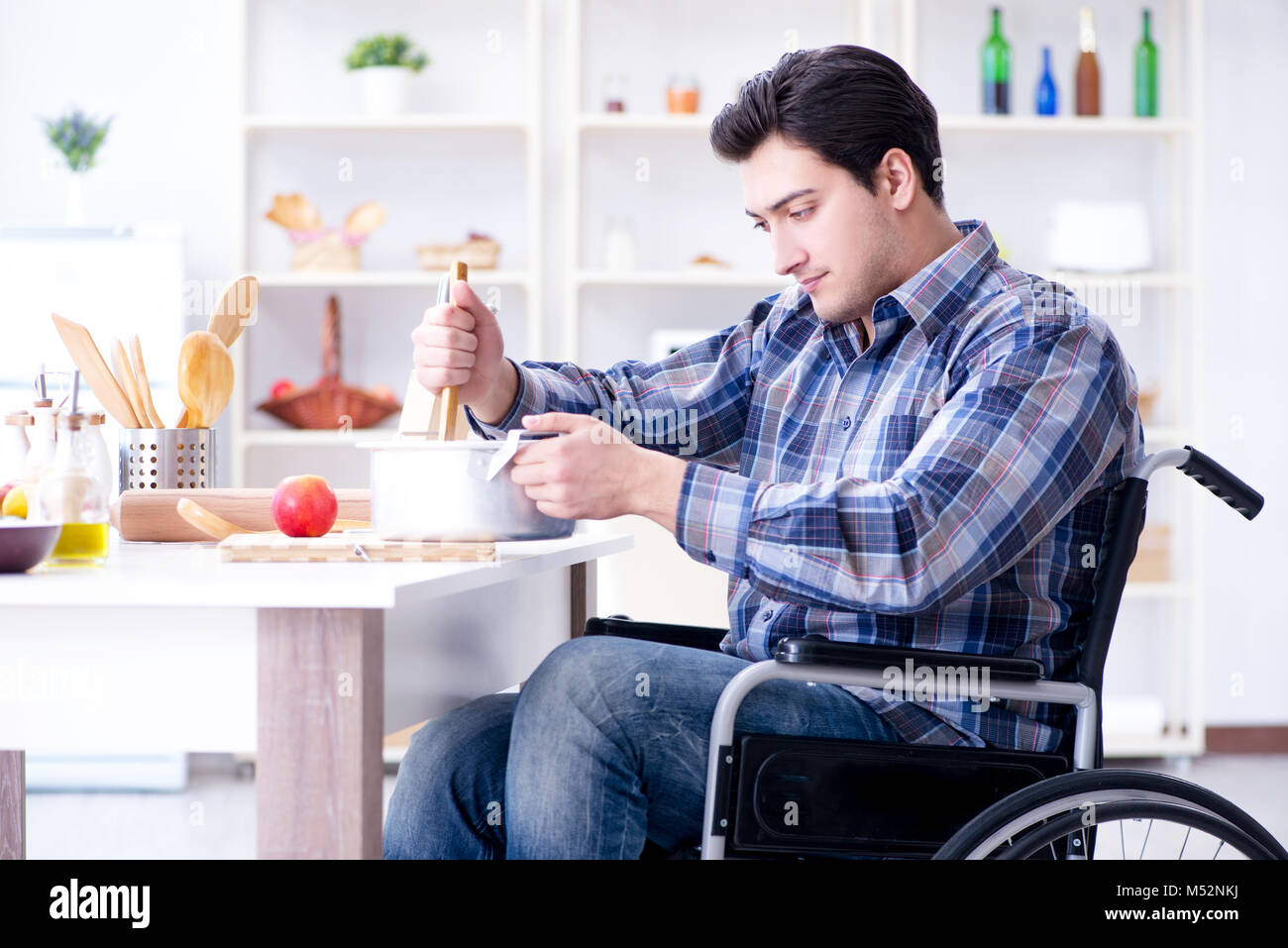 Disabled man preparing soup at kitchen Stock Photo - Alamy