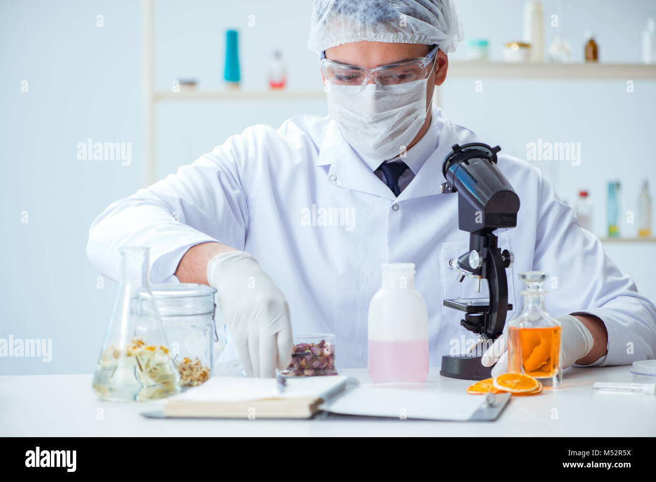 The chemist mixing perfumes in the lab Stock Photo - Alamy