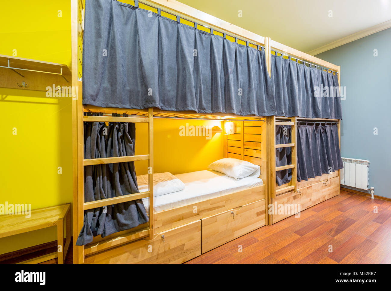 The hostel dormitory beds arranged in room Stock Photo - Alamy