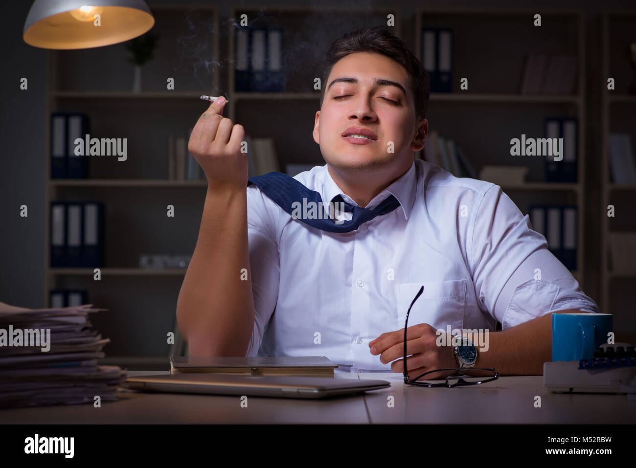 The man staying late at night and smoking marijuana Stock Photo - Alamy