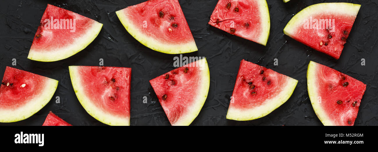 Slices of ripe watermelon on a black stone background Stock Photo - Alamy