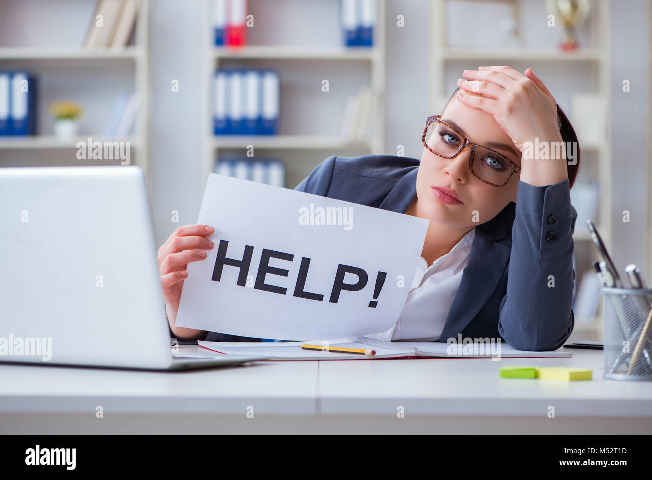 Businesswoman pleading for help in office Stock Photo - Alamy