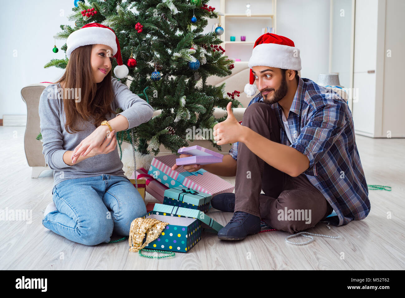 Young woman receiving gold watch as christmas gift Stock Photo - Alamy
