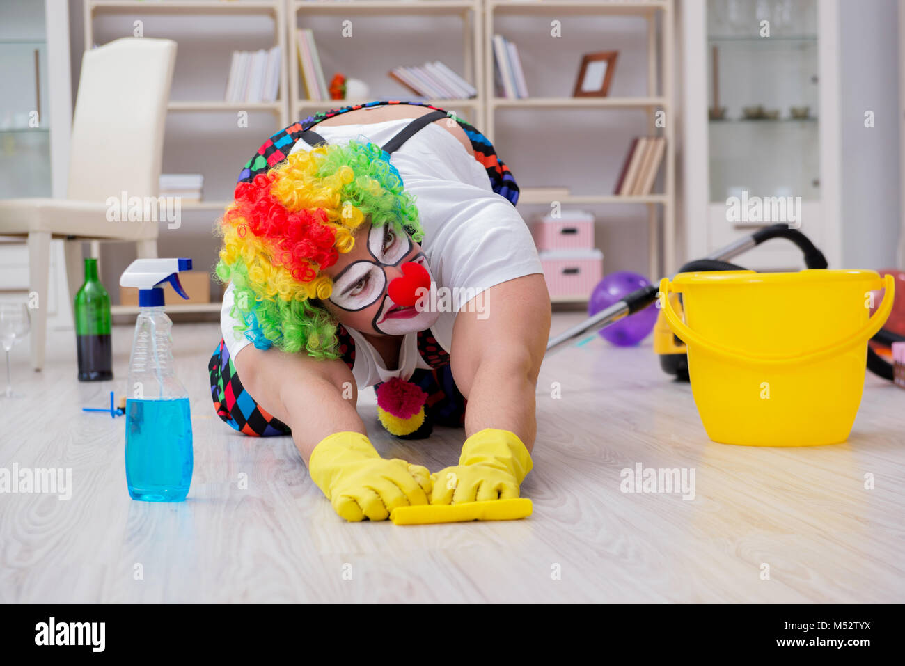 Funny clown doing cleaning at home Stock Photo - Alamy