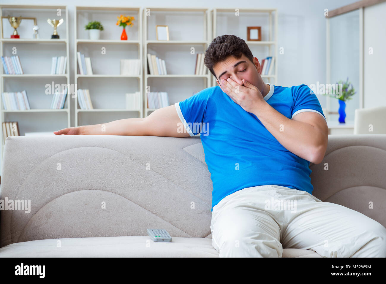 Man sweating excessively smelling bad at home Stock Photo - Alamy