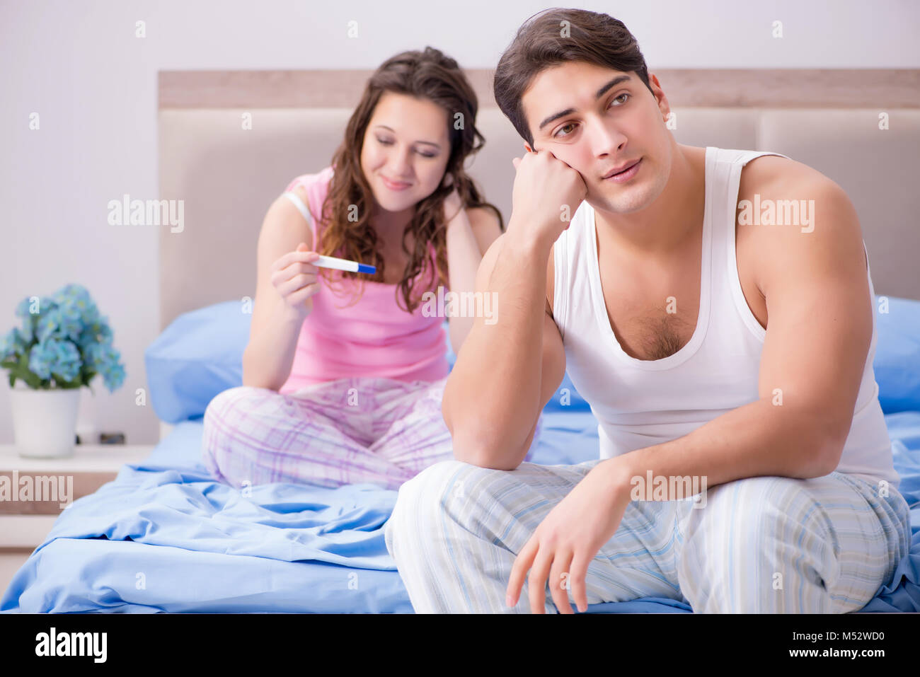 Young family with pregnancy test results Stock Photo - Alamy