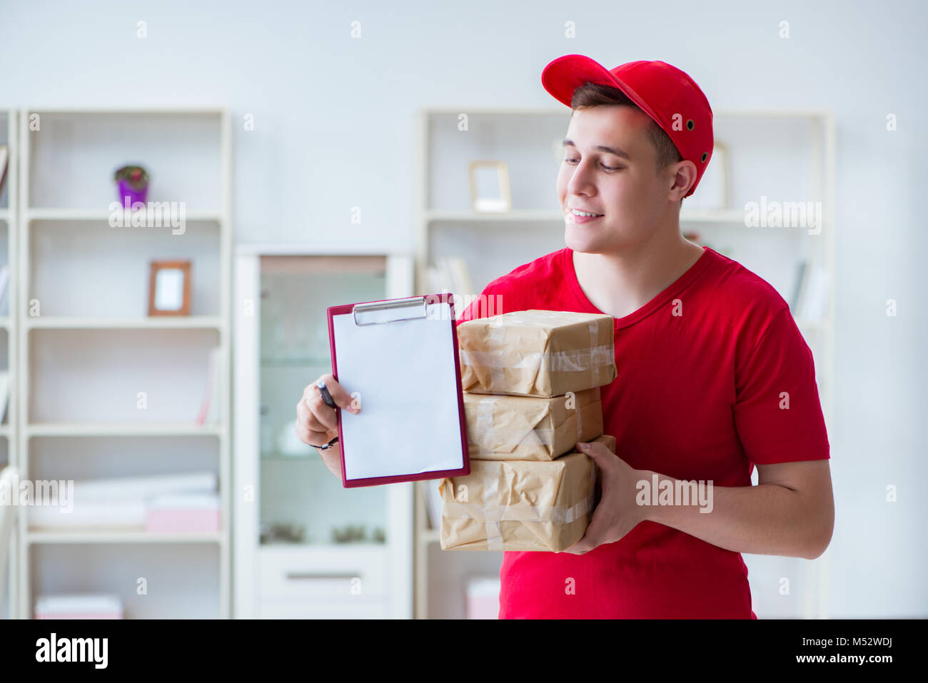 Post man delivering a parcel package Stock Photo - Alamy