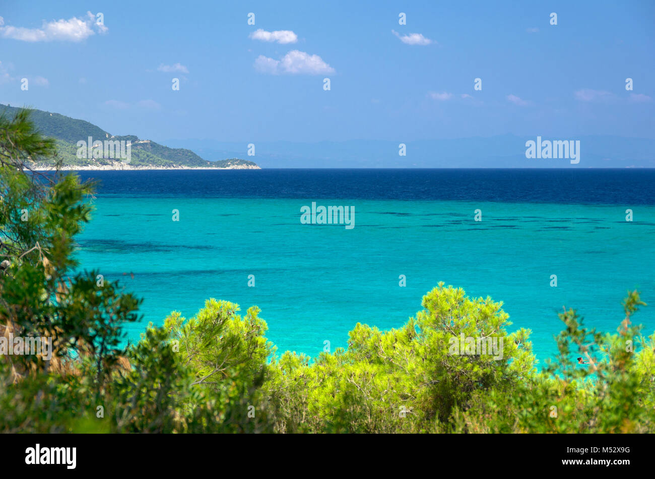 Blue sea shore under clear sky Stock Photo - Alamy