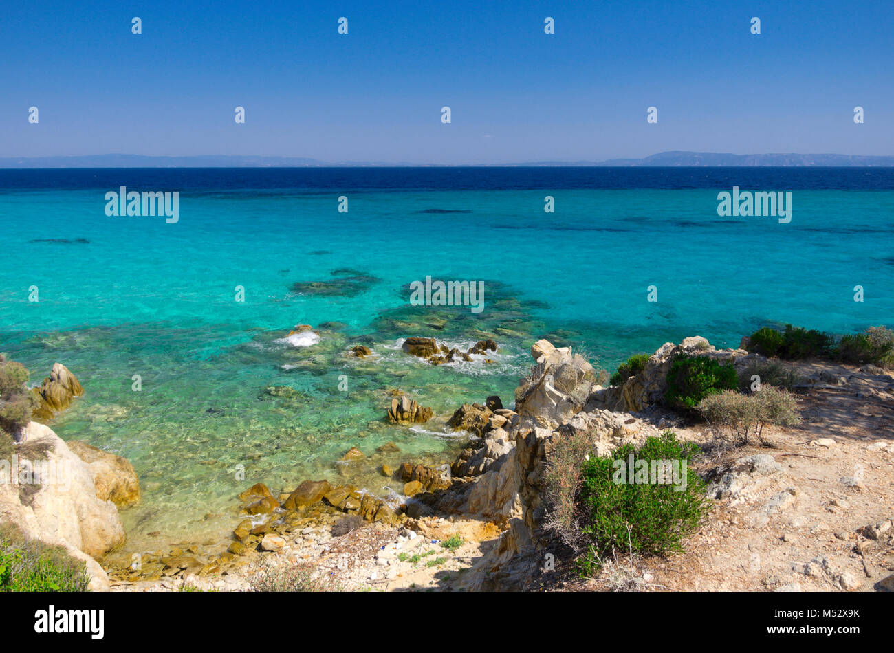 Blue sea shore under clear sky Stock Photo - Alamy