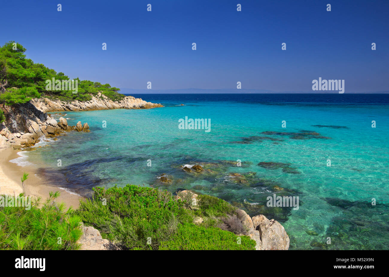 Blue sea shore under clear sky Stock Photo - Alamy
