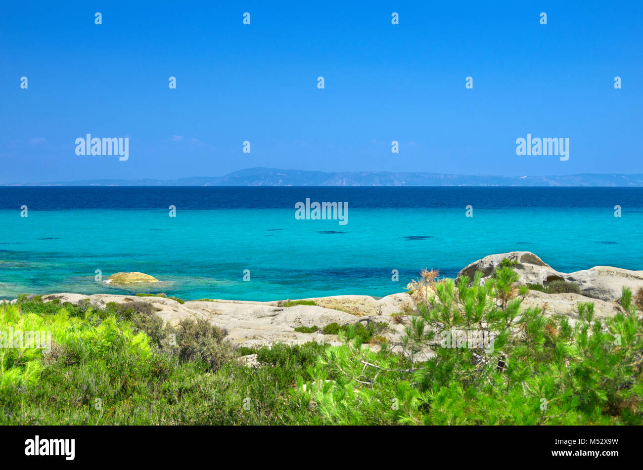 Blue sea shore under clear sky Stock Photo - Alamy