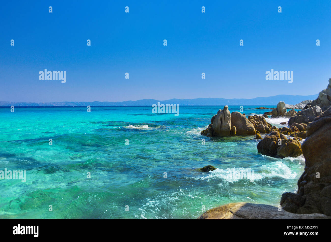 Blue sea shore under clear sky Stock Photo - Alamy