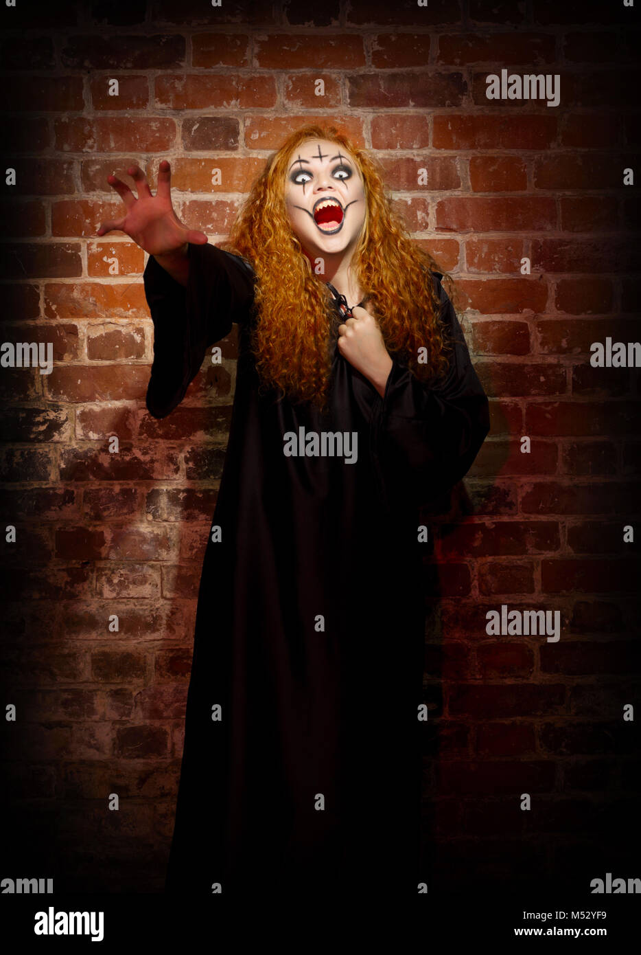 Scary witch on brick wall Stock Photo - Alamy