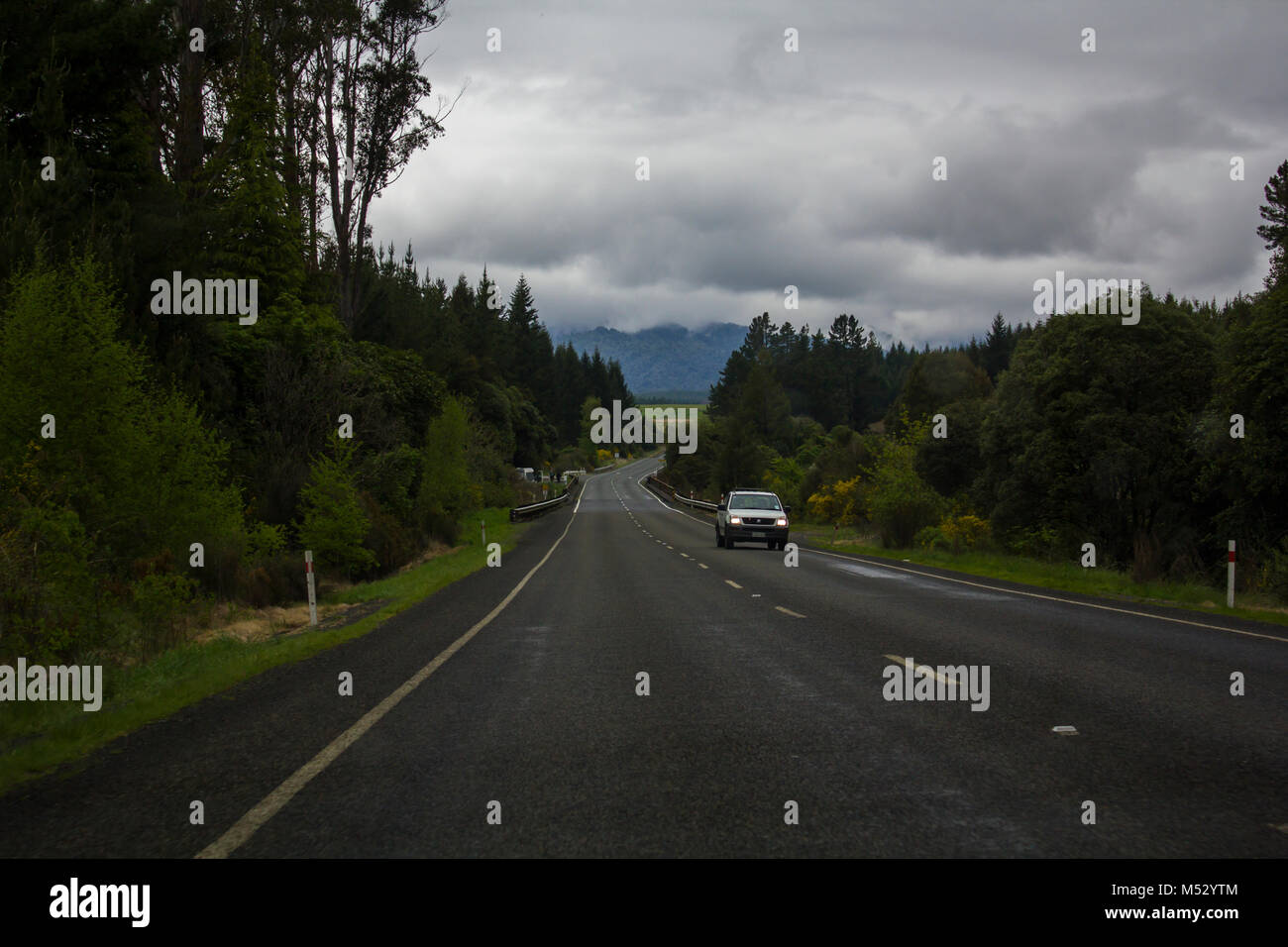 A car driving in empty asphalt road in New Zealand Stock Photo - Alamy