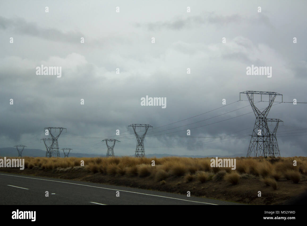 Power Pylons on Desert Road Stock Photo - Alamy