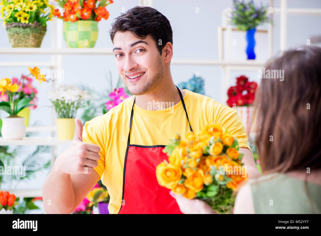 Florist selling flowers in a flower shop Stock Photo - Alamy