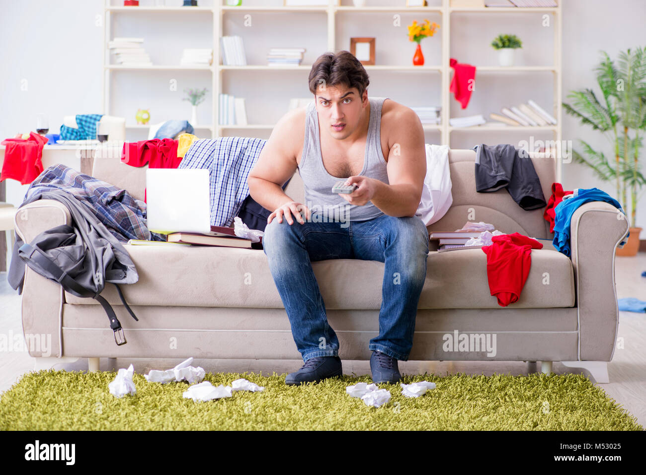 Young man working studying in messy room Stock Photo - Alamy