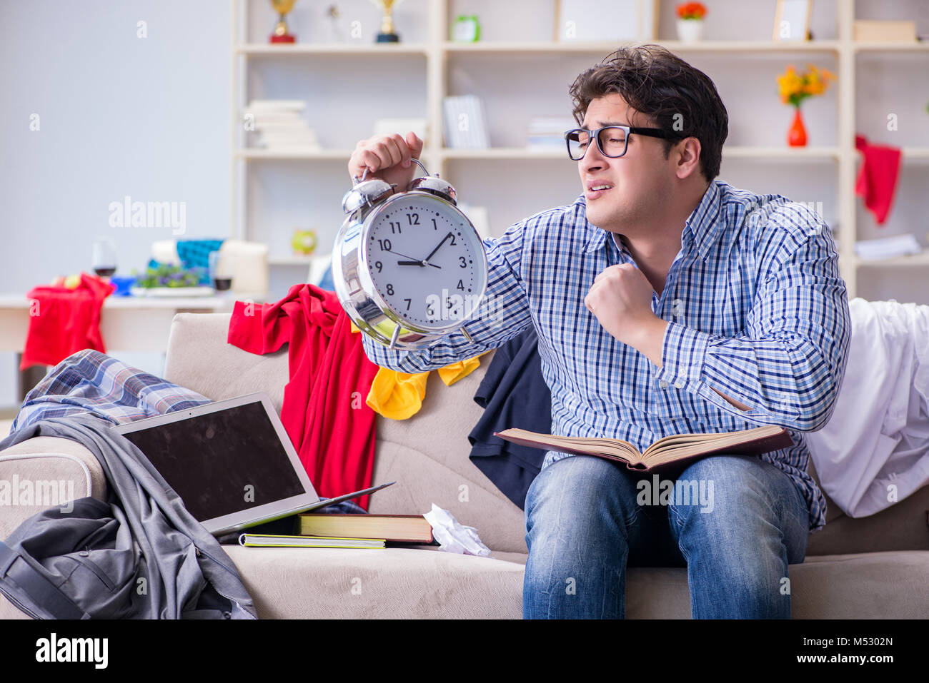 Young man working studying in messy room Stock Photo - Alamy