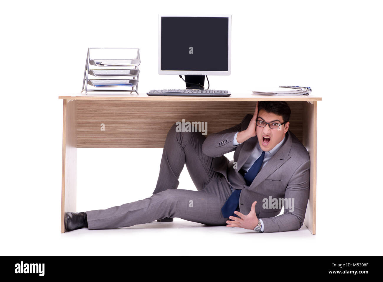 Person hiding under desk Cut Out Stock Images & Pictures - Alamy