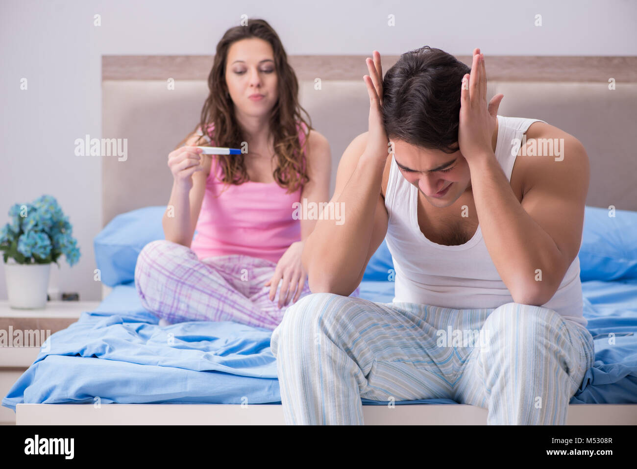 Young family with pregnancy test results Stock Photo - Alamy