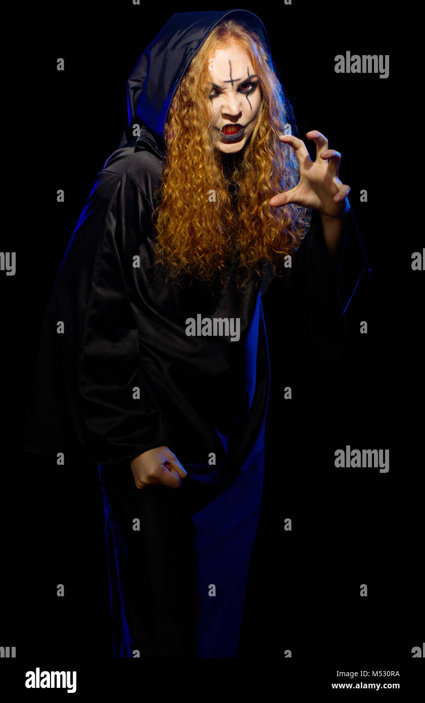 Scary witch isolated on black Stock Photo - Alamy