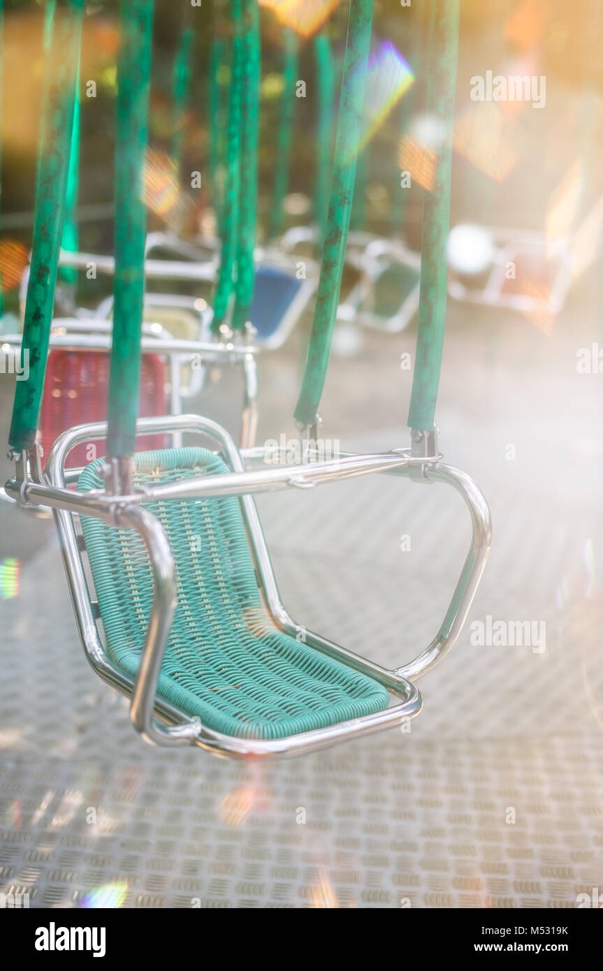 Green empty carousel seat at summer funfair Stock Photo - Alamy