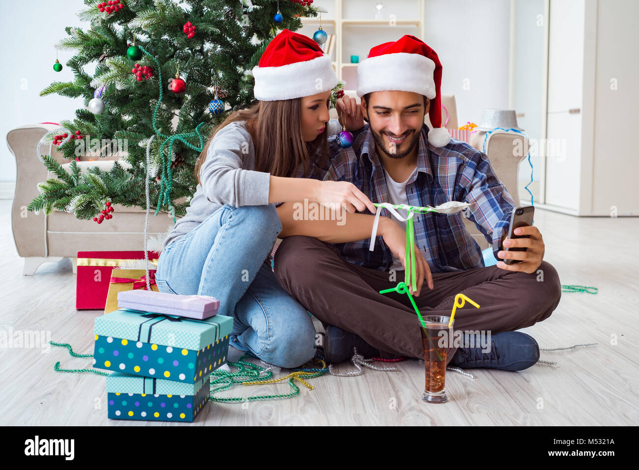 Young pair taking selfies during christmas Stock Photo - Alamy