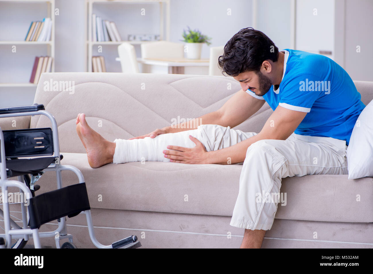 Injured young man recovering at home Stock Photo - Alamy