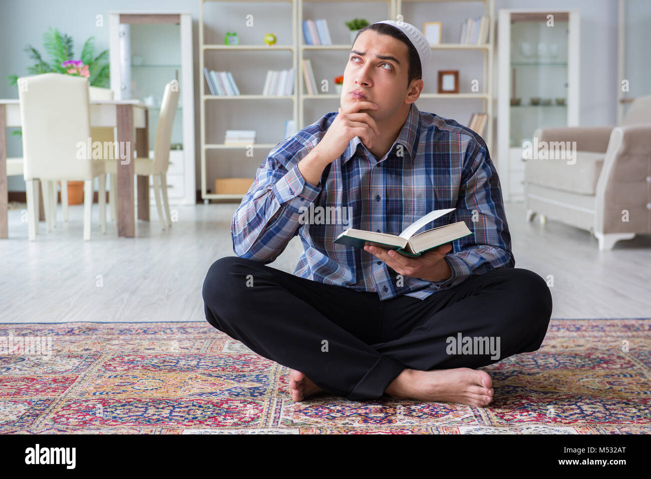 Young muslim man praying at home Stock Photo - Alamy
