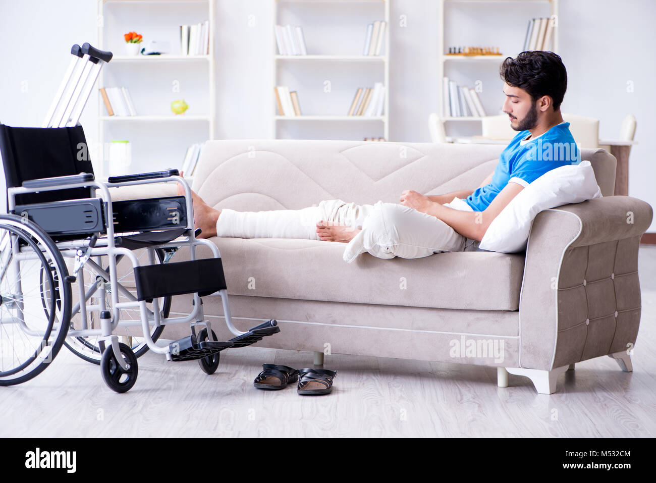 Injured young man recovering at home Stock Photo - Alamy
