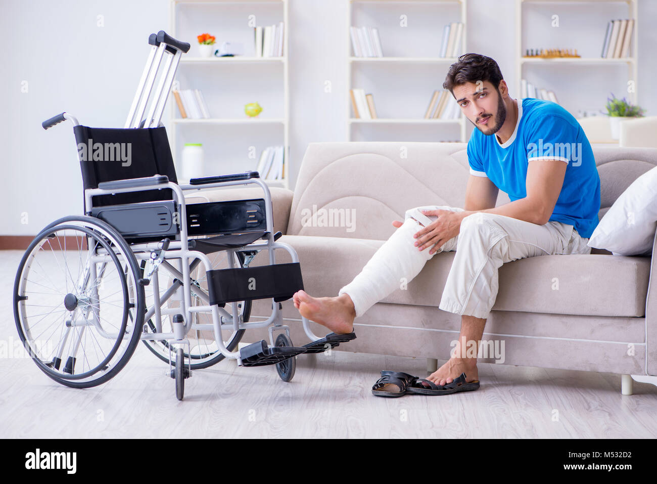 Injured young man recovering at home Stock Photo - Alamy