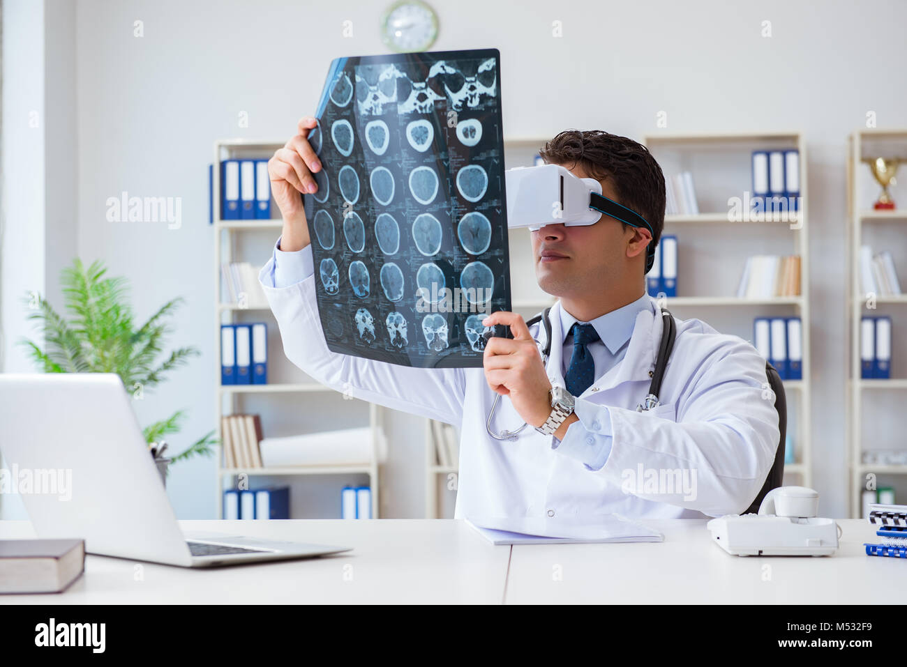 Young doctor looking at MRI scan through VR glasses Stock Photo - Alamy