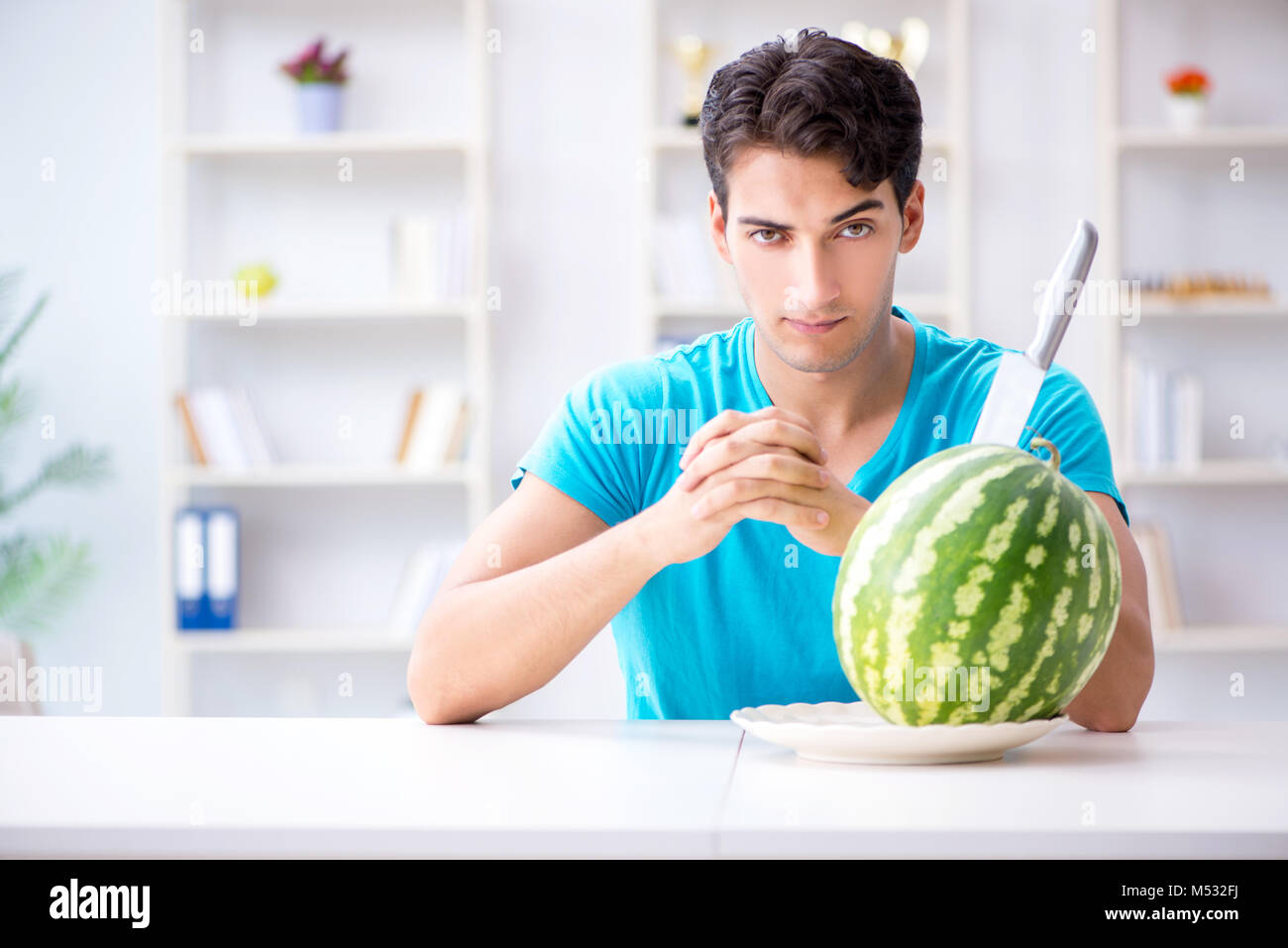 Man eating watermelon at home Stock Photo - Alamy