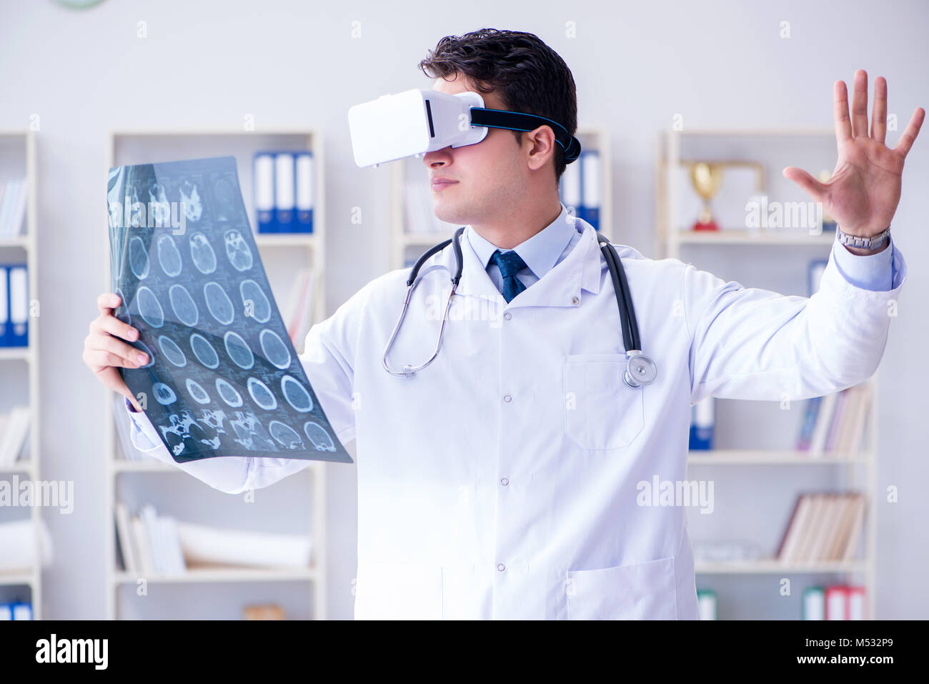 Young doctor looking at MRI scan through VR glasses Stock Photo - Alamy