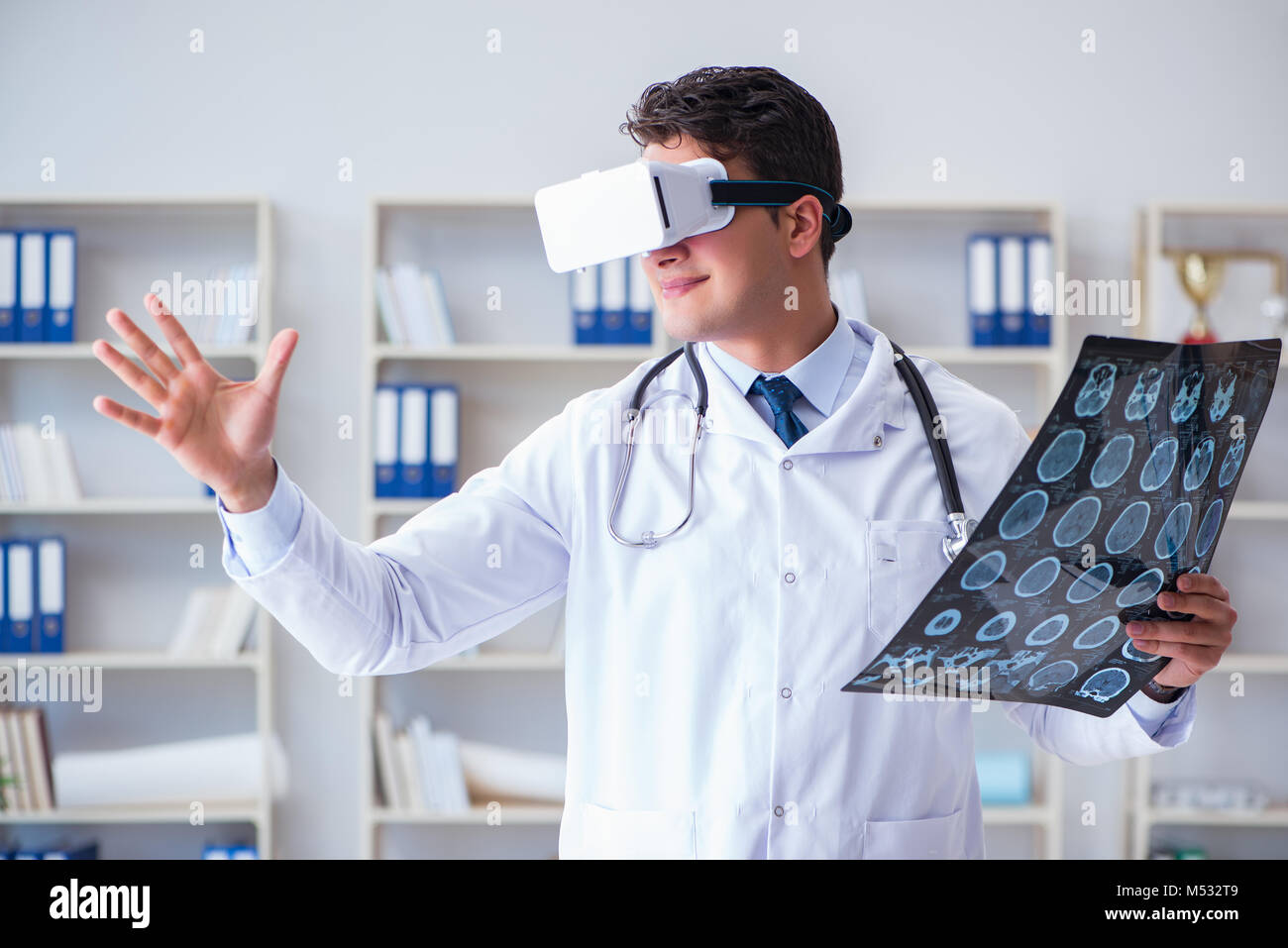 Young doctor looking at MRI scan through VR glasses Stock Photo - Alamy