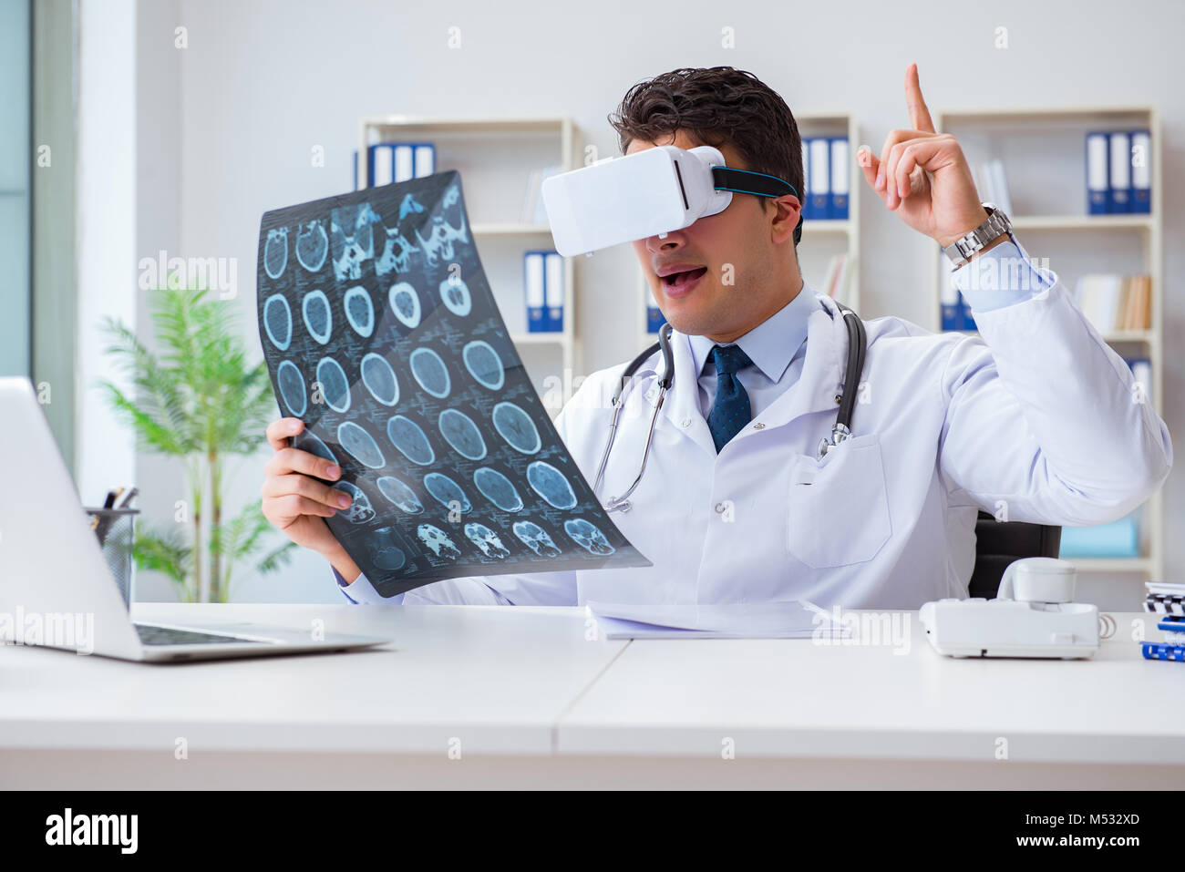 Young doctor looking at MRI scan through VR glasses Stock Photo - Alamy