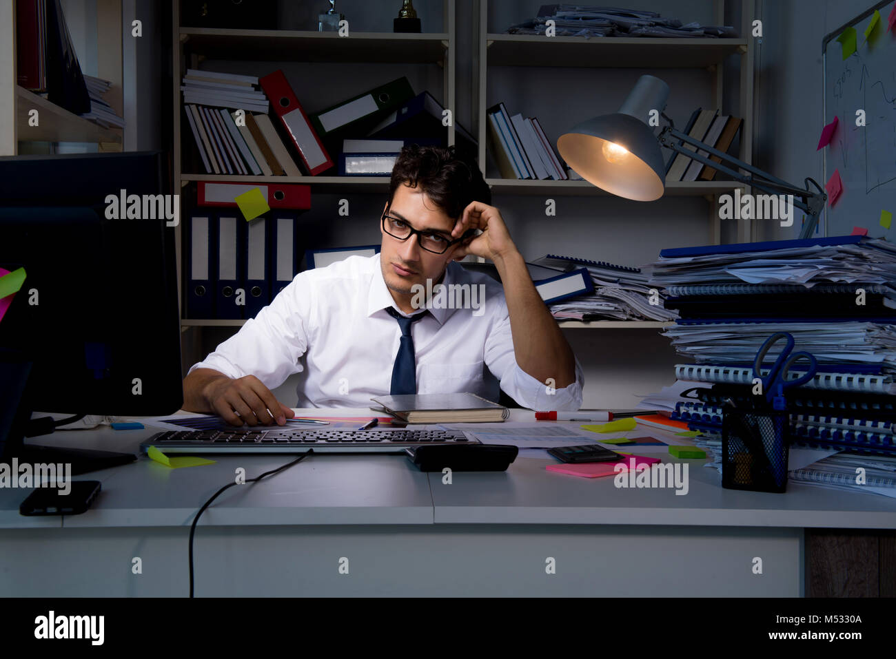 Man businessman working late hours in the office Stock Photo - Alamy