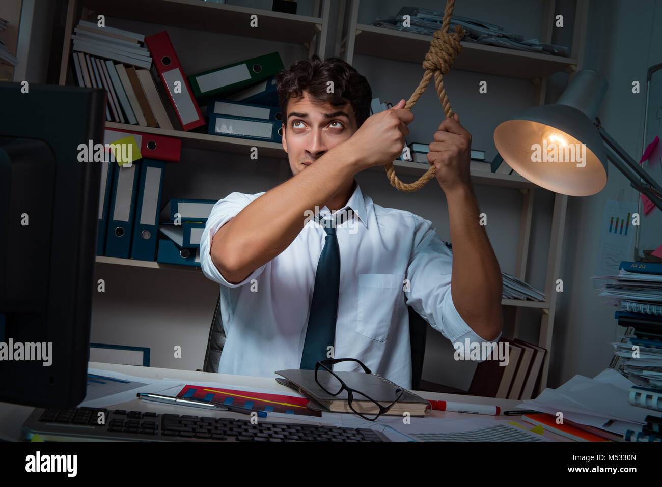 Man businessman working late hours in the office Stock Photo - Alamy