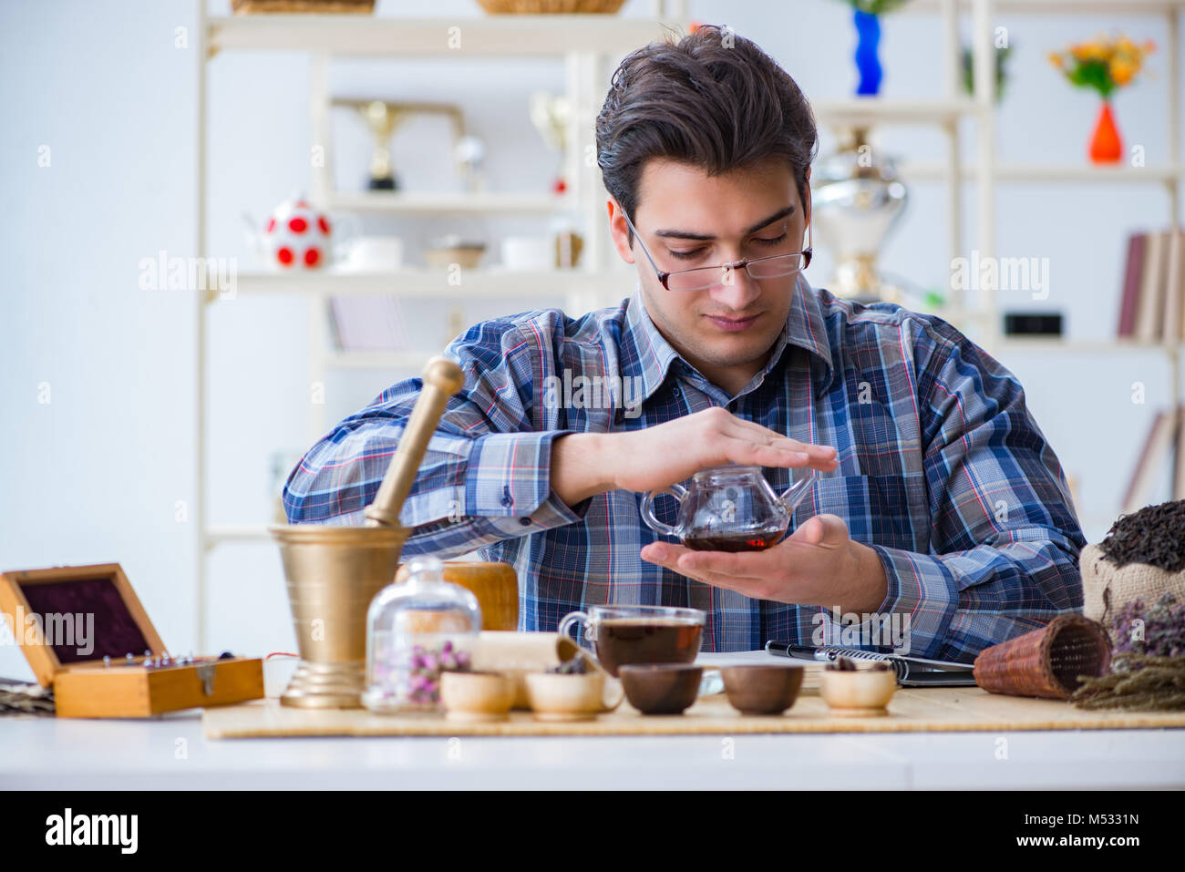 Tea expert brewing cup of drink hi-res stock photography and images - Alamy