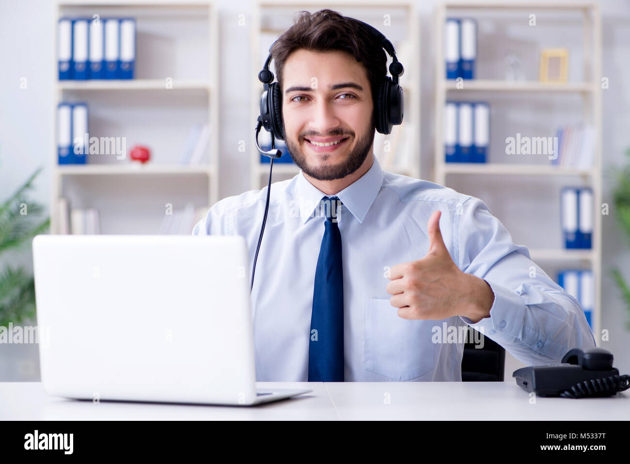 Call center office thumbs hi-res stock photography and images - Alamy
