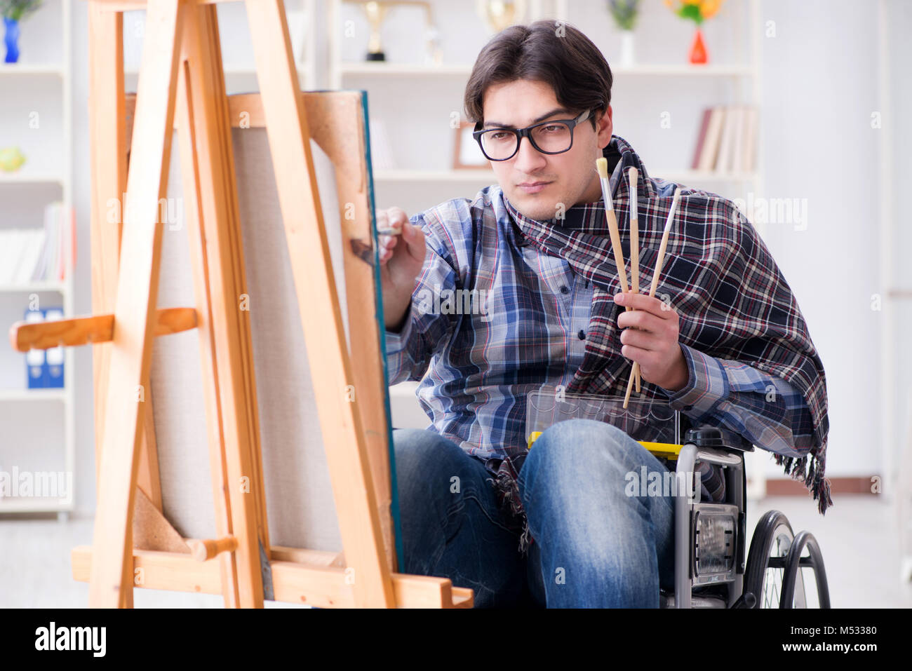 Disabled artist painting picture in studio Stock Photo - Alamy
